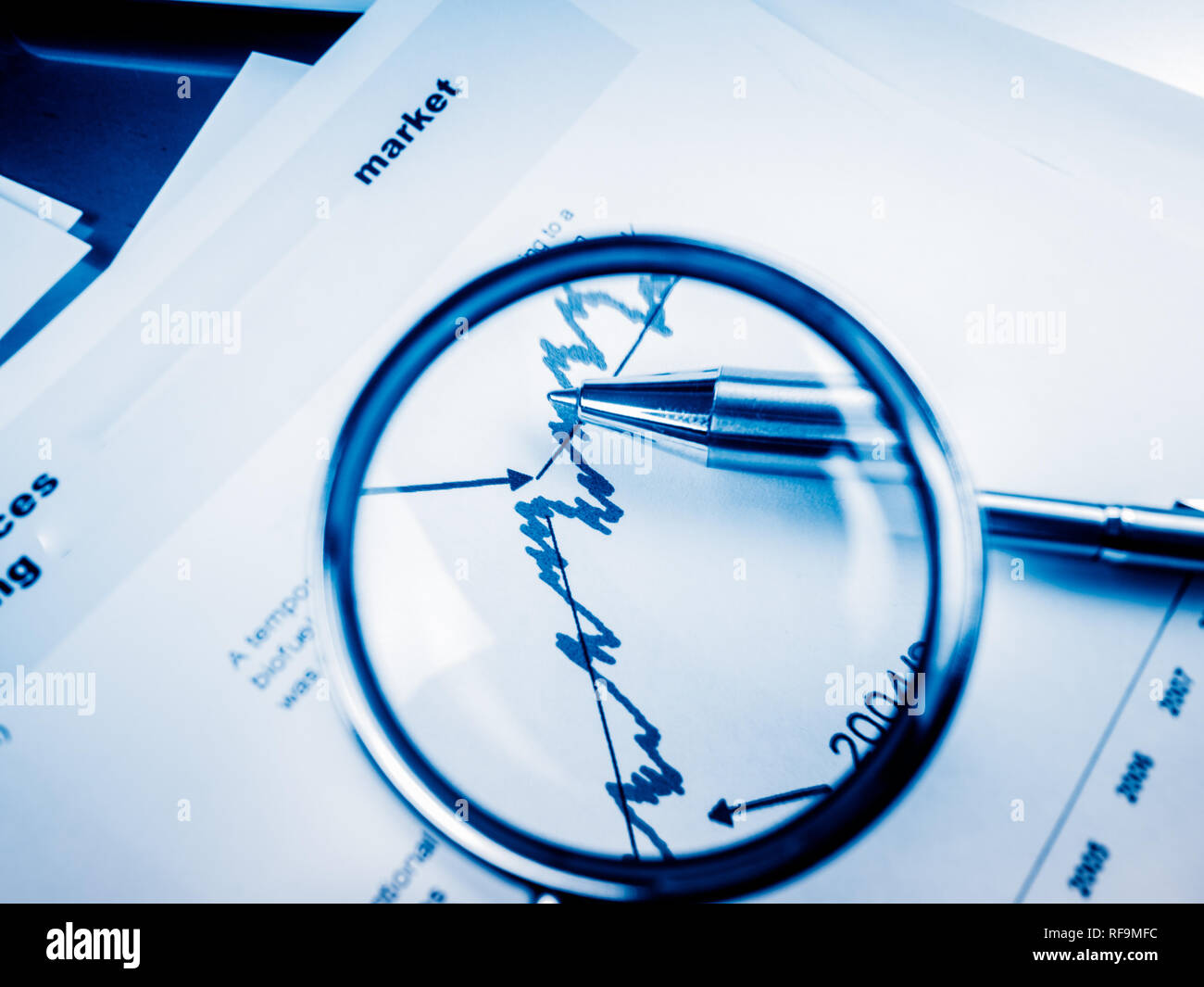 Business Data Analyzing, with magnifying glass and other on the desk ...