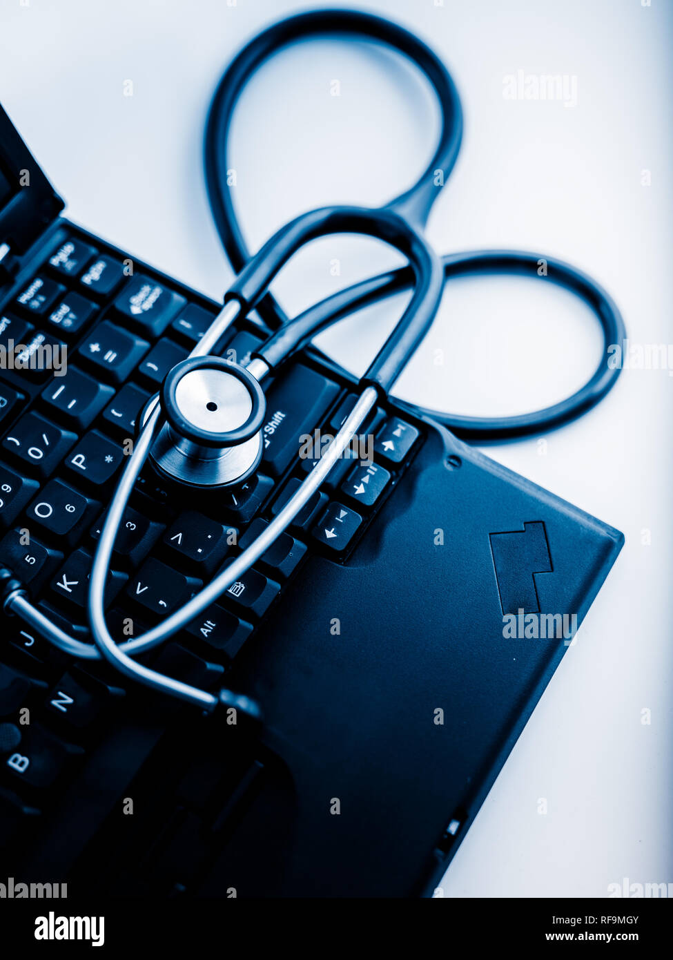 Electronic medical, stethoscope on PC/Laptop/Keyboard， blue toned ...
