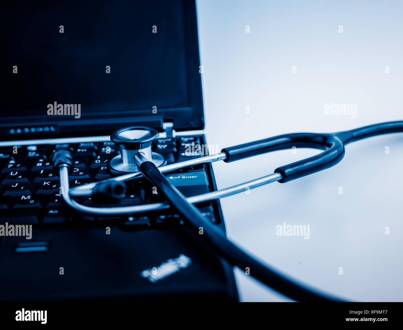 Electronic medical, stethoscope on PC/Laptop/Keyboard， blue toned ...