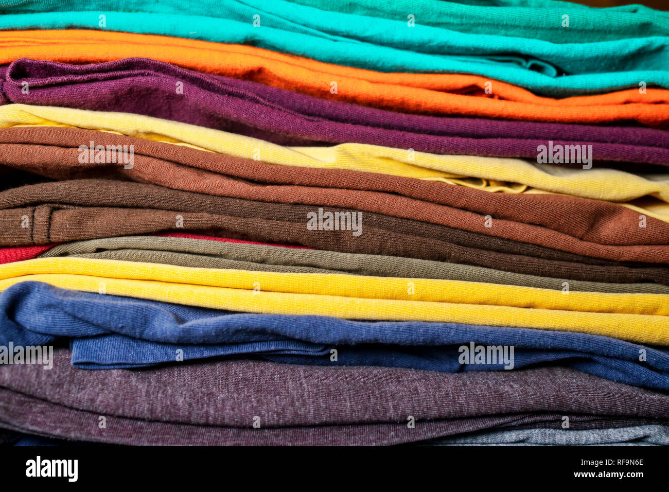 stack of worn t-shirts in various colors in wardrobe Stock Photo - Alamy