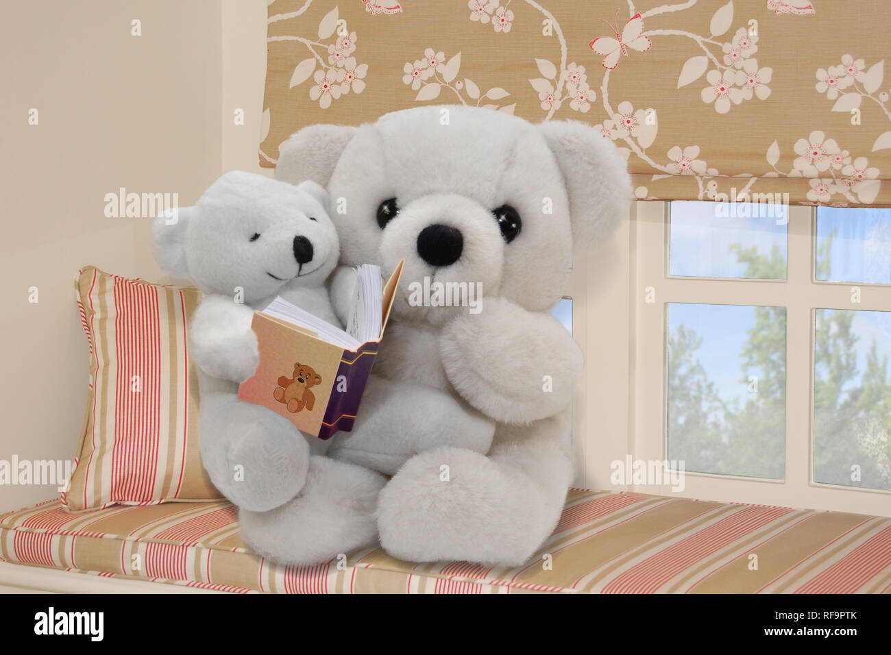 Parent and child teddy bears reading book on bench in front of picture ...
