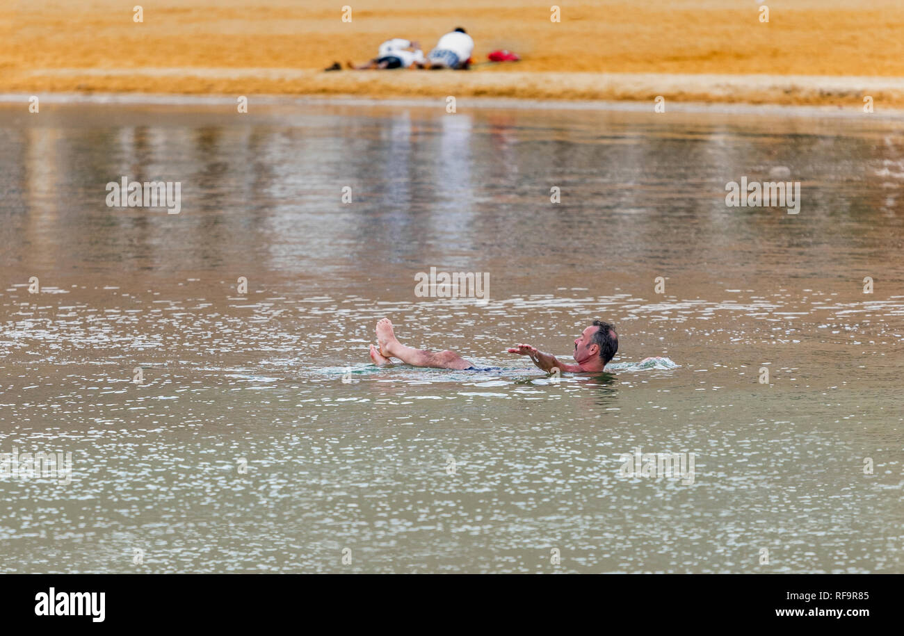 Tourists floating in the Dead Sea waters. Israel Stock Photo - Alamy