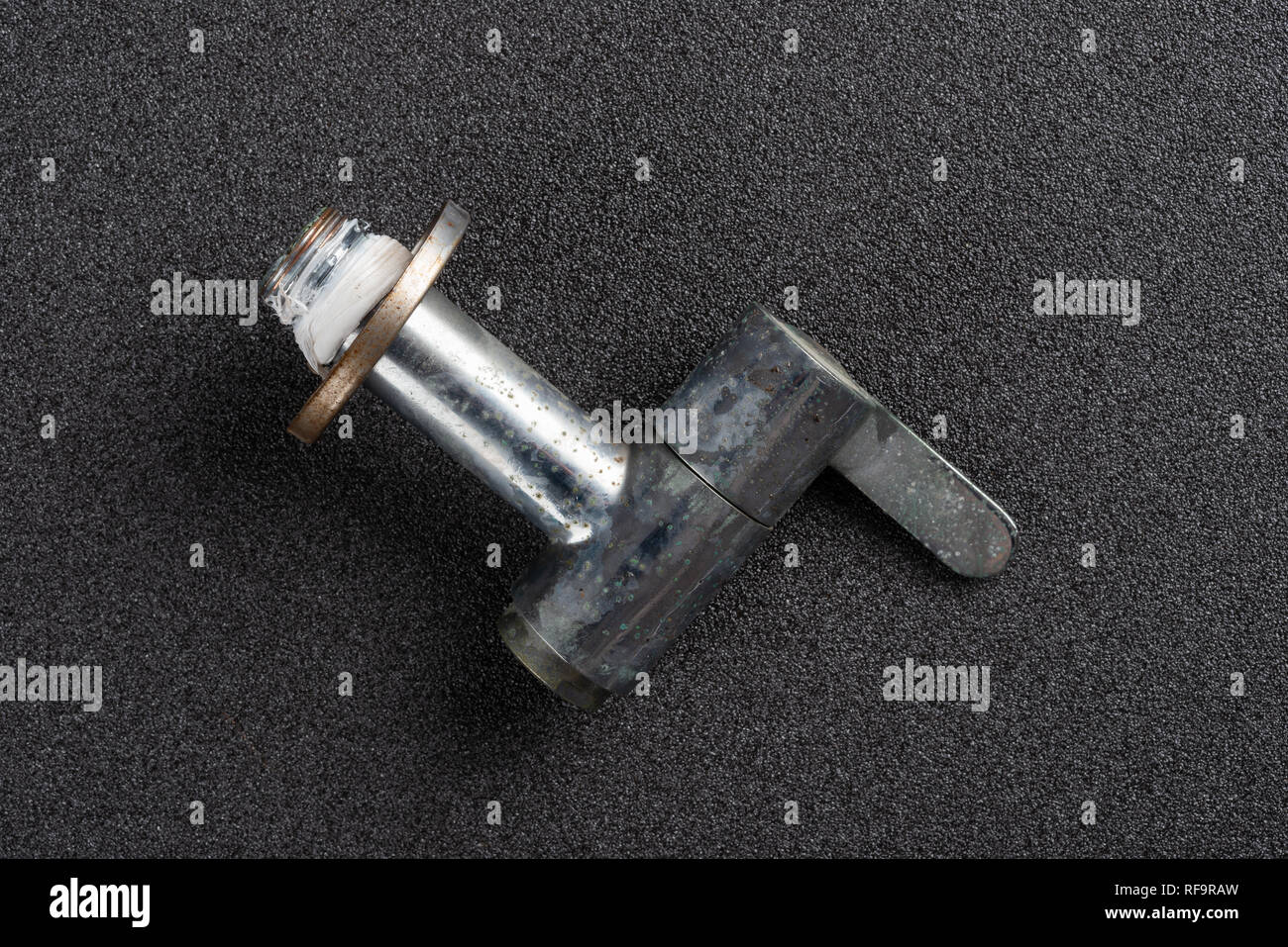 top view rusty steel tap on a dark background Stock Photo - Alamy