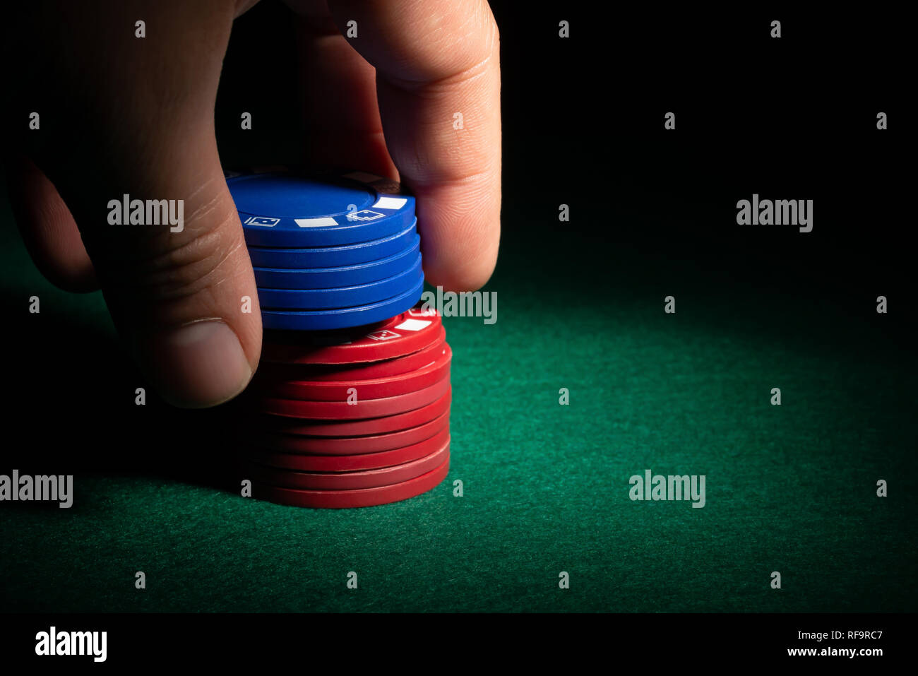 Hand putting down poker chips hi-res stock photography and images - Alamy