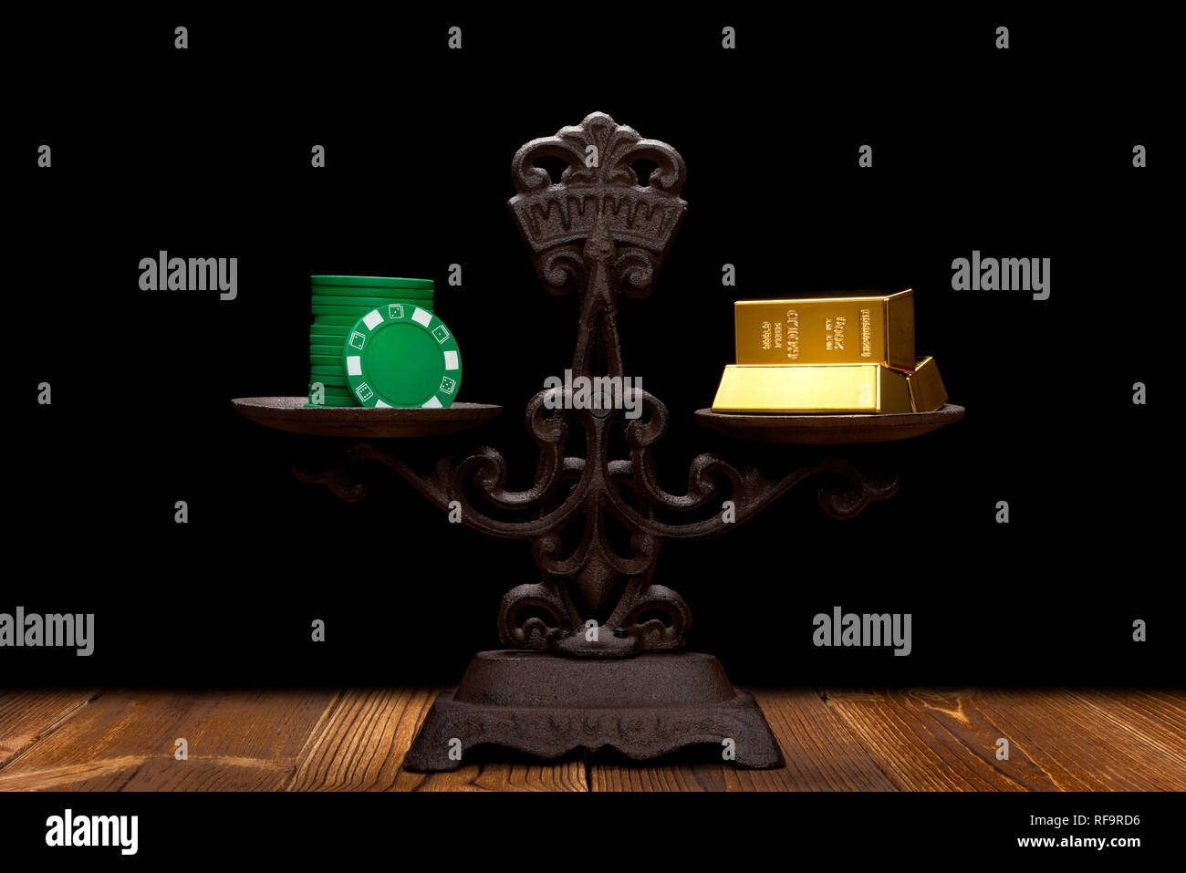 cashino chips and gold bars on a balanced scale Stock Photo - Alamy