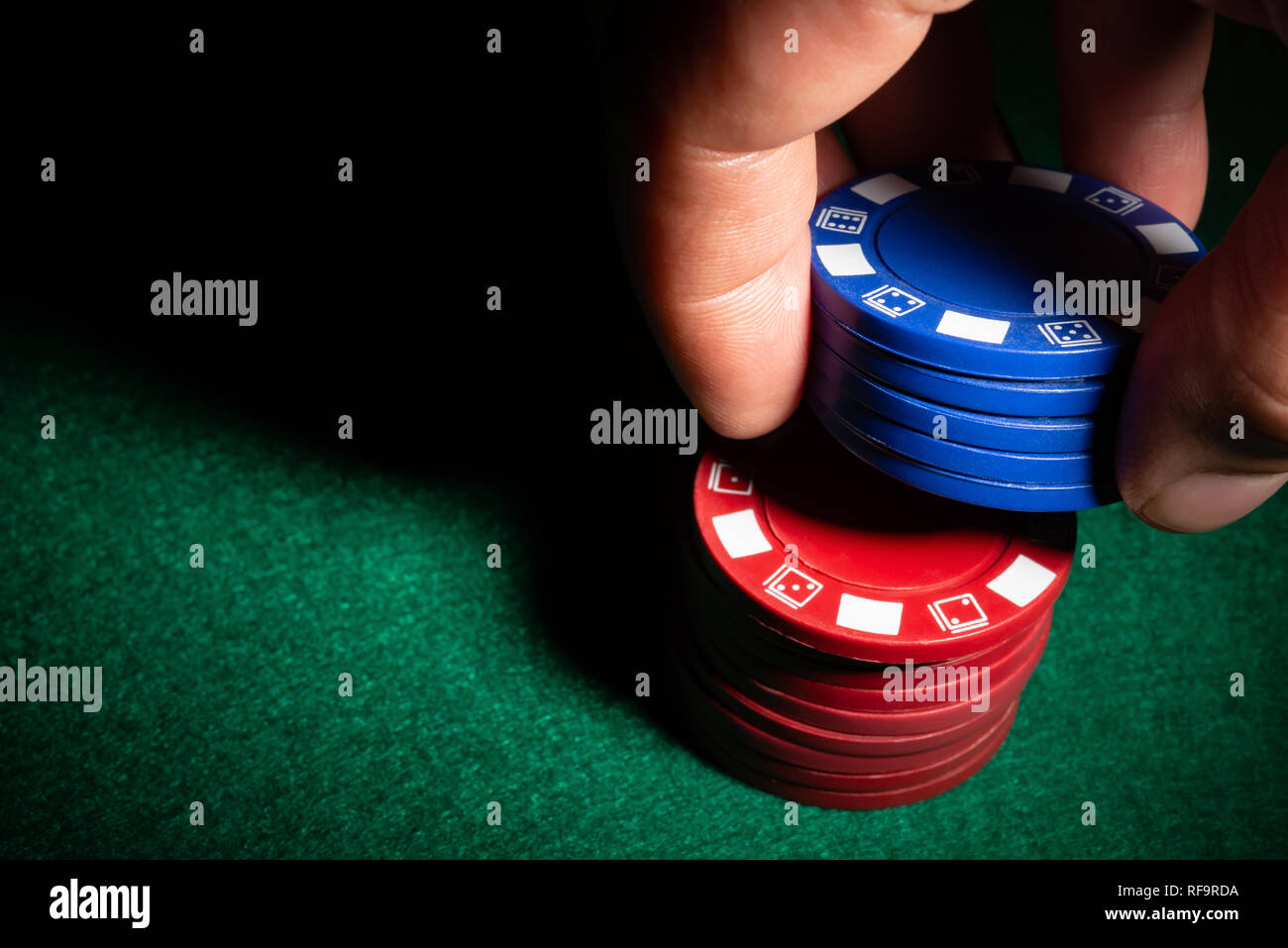 Hand putting down poker chips hi-res stock photography and images - Alamy