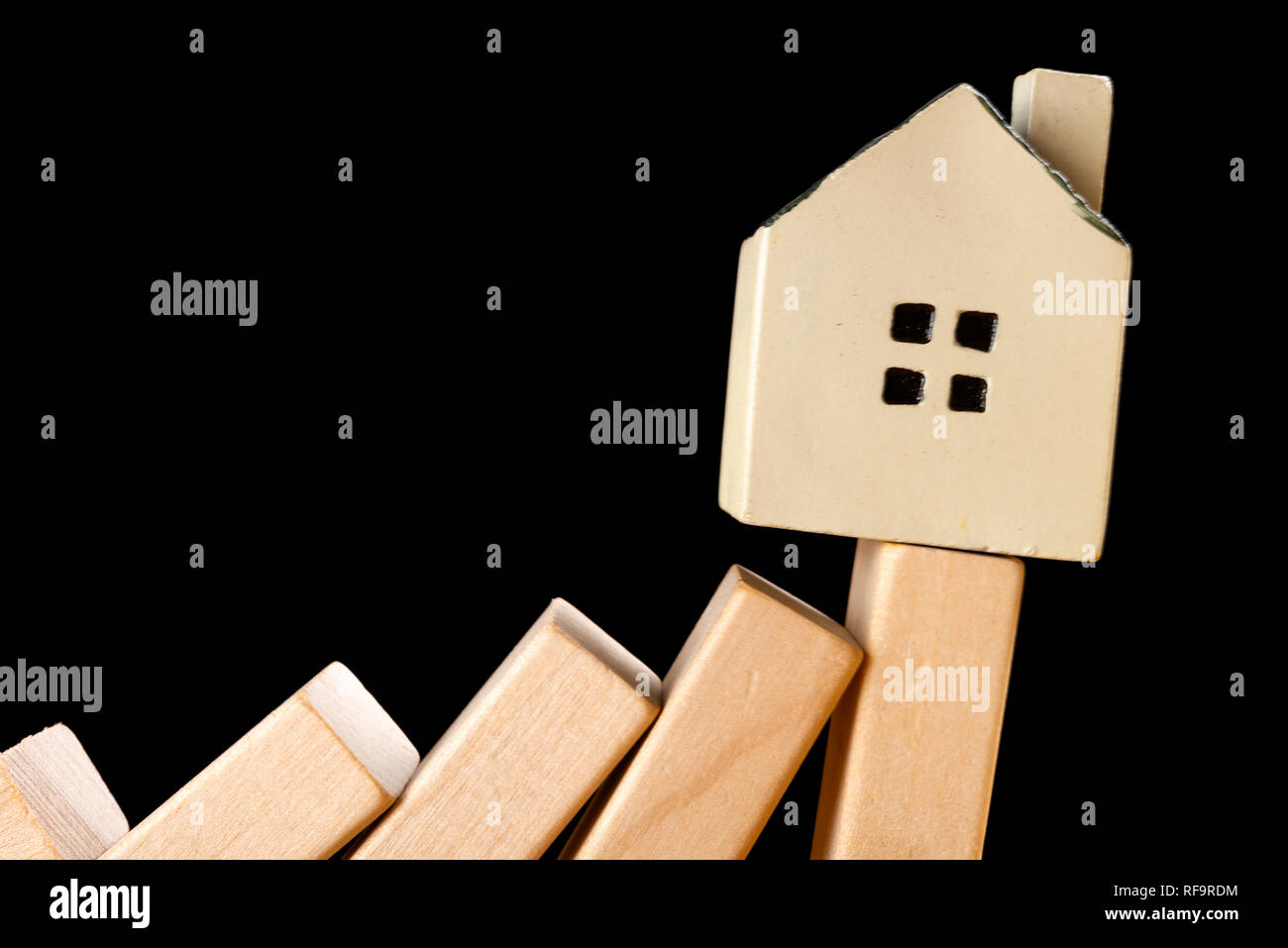 house falling down from a domino base concept of real estate investment ...