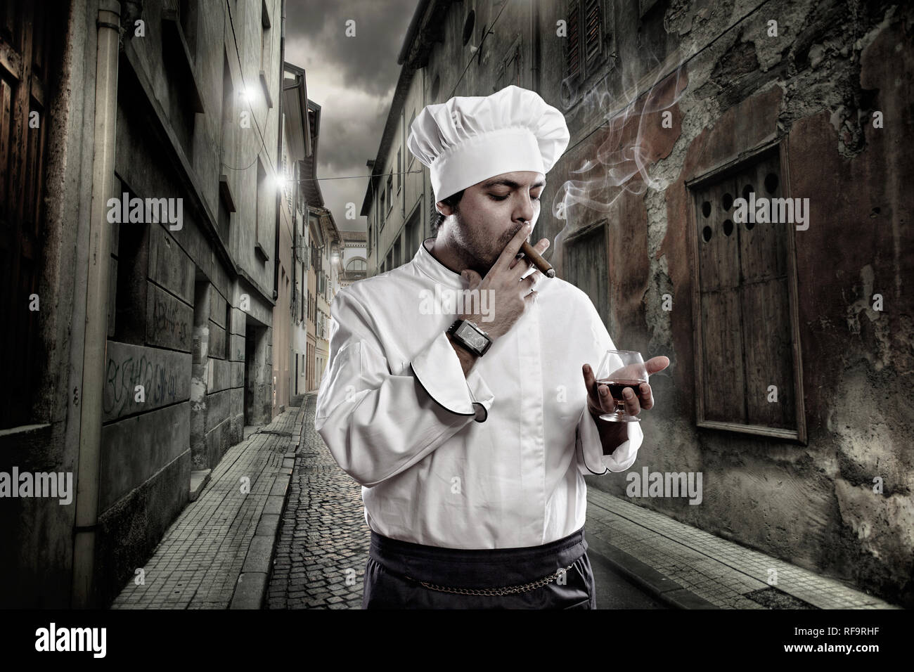 Chef with cognac and cigar smoking in dark street Stock Photo - Alamy
