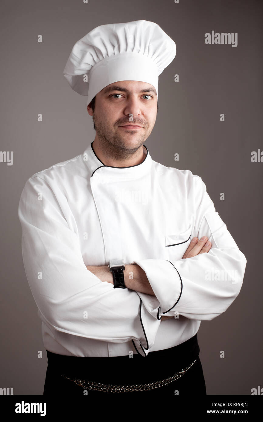 Handsome chef posing against gray background Stock Photo - Alamy