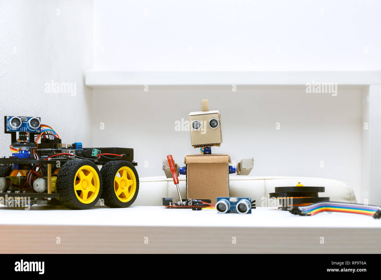 The robot holds a screwdriver in its hands to assemble the robot, and ...