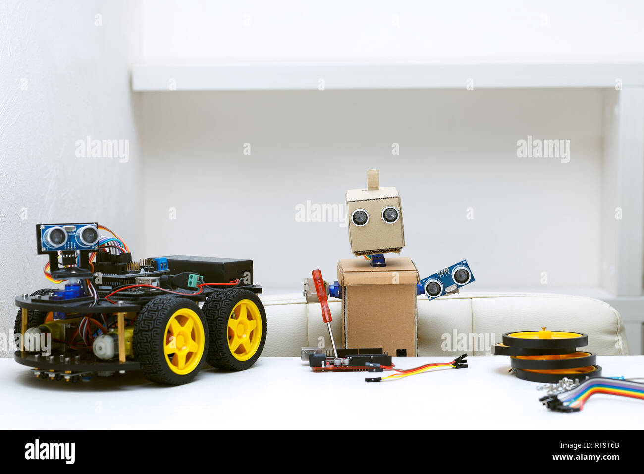 The robot holds in its hands the parts for assembling the robot, and ...