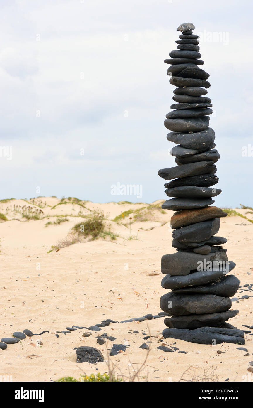 Cairn made of Black Volcanic Pebbles on a Beach on the Southern Coast ...