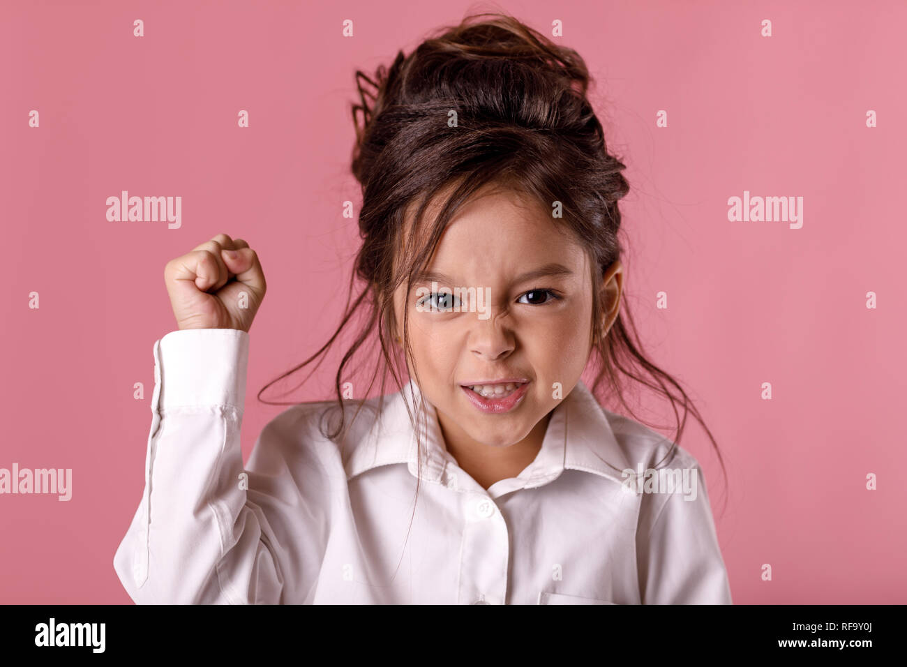 angry little child girl in white shirt with hairstyle Stock Photo - Alamy