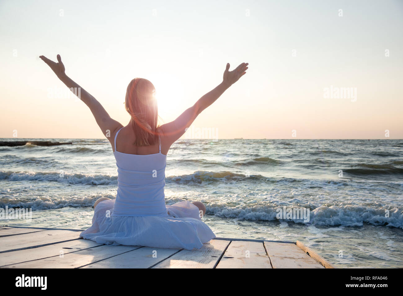serenity and yoga practicing at the sea. sunrise Stock Photo - Alamy