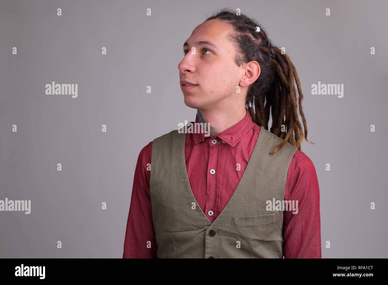 Face of young handsome businessman with dreadlocks thinking Stock Photo ...