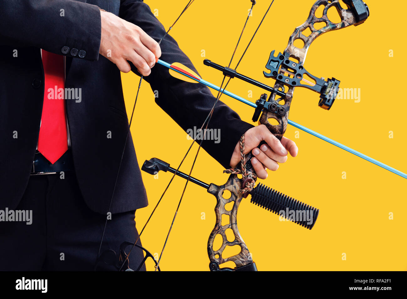 Businessman aiming at target with bow and arrow, isolated on yellow ...