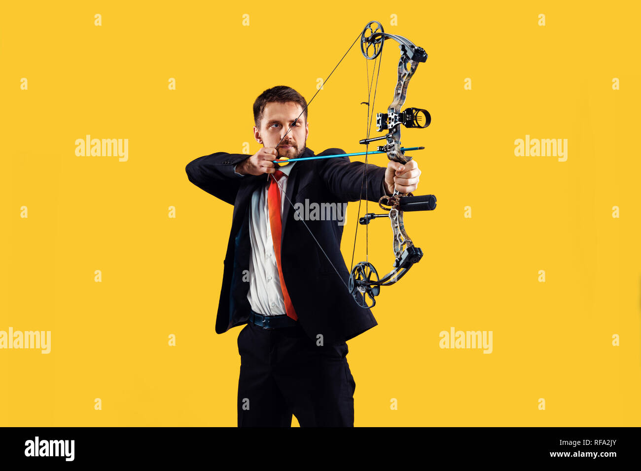 Businessman aiming at target with bow and arrow, isolated on yellow ...