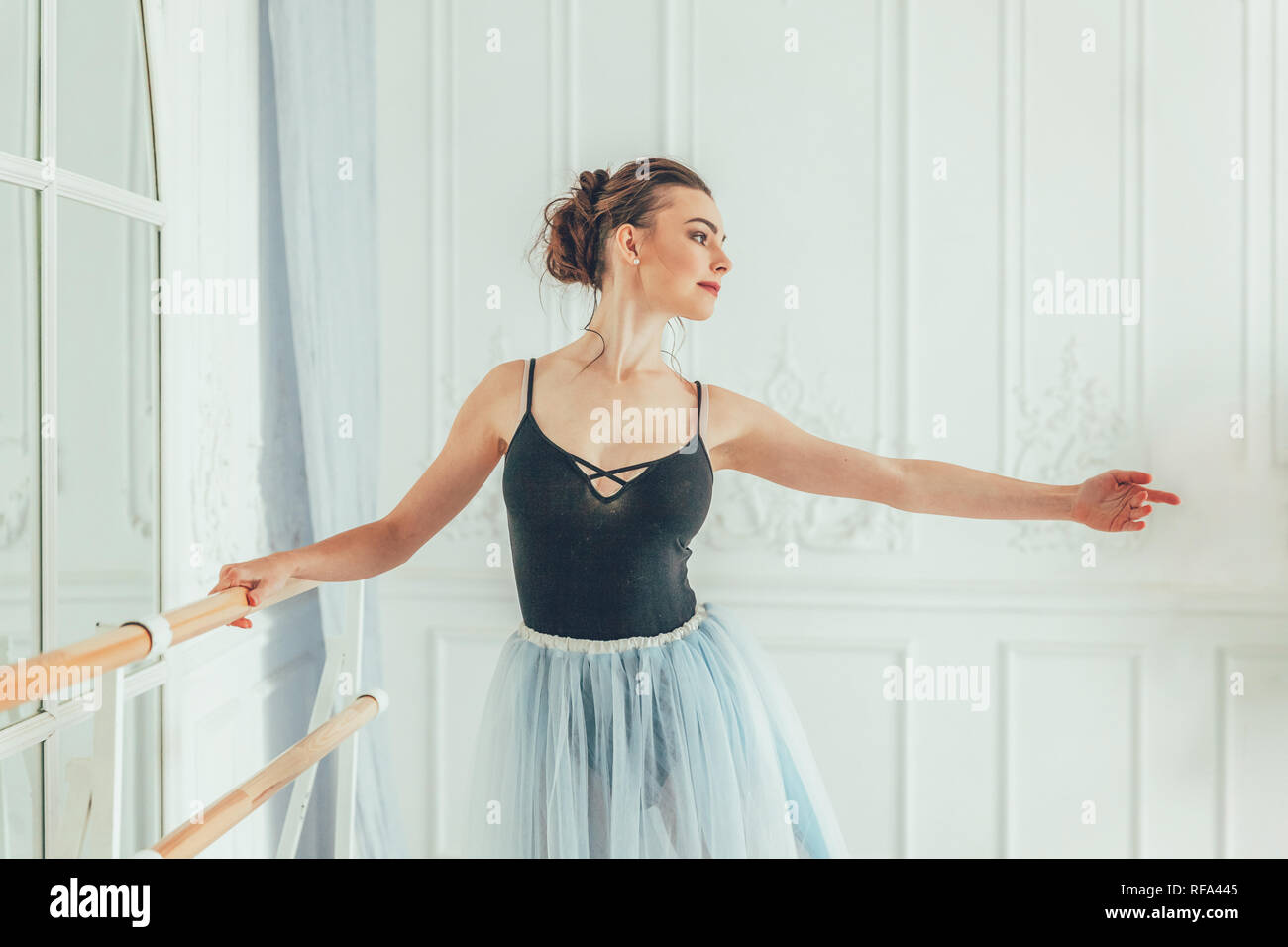 Young classical ballet dancer woman in dance class. Beautiful graceful ballerina practice ballet ...