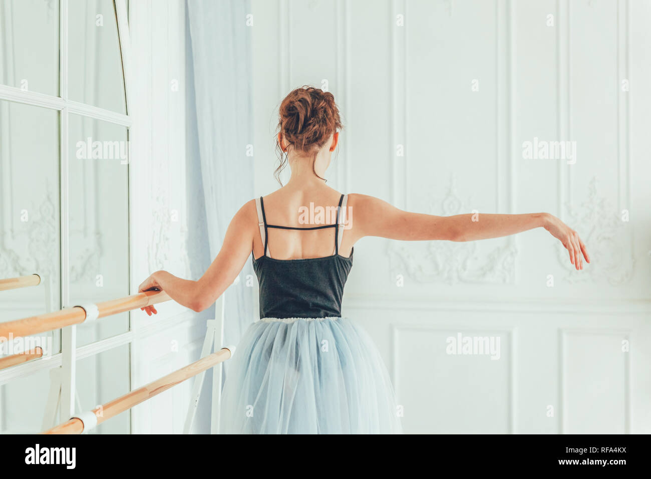 Young classical ballet dancer woman in dance class. Beautiful graceful ballerina practice ballet ...
