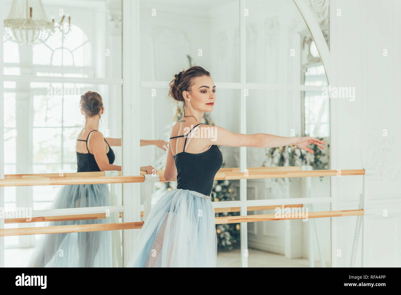 Young classical ballet dancer woman in dance class. Beautiful graceful ballerina practice ballet ...