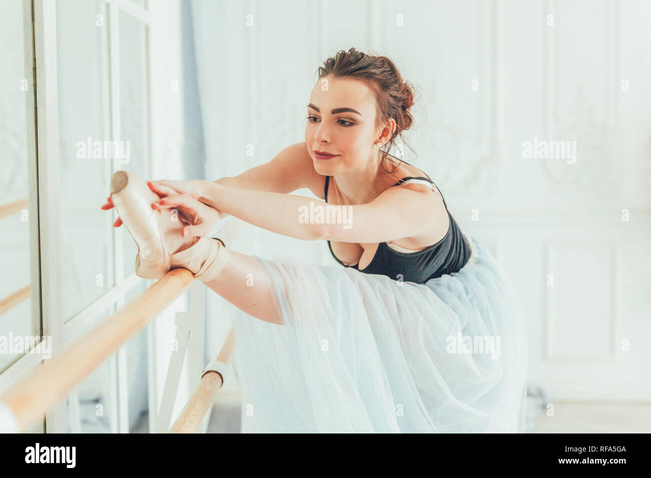 Young classical ballet dancer woman in dance class. Beautiful graceful ballerina practice ballet ...