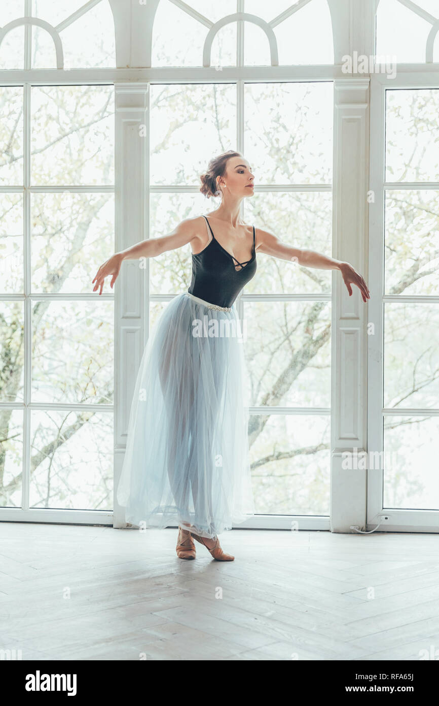 Young classical ballet dancer woman in dance class. Beautiful graceful ...