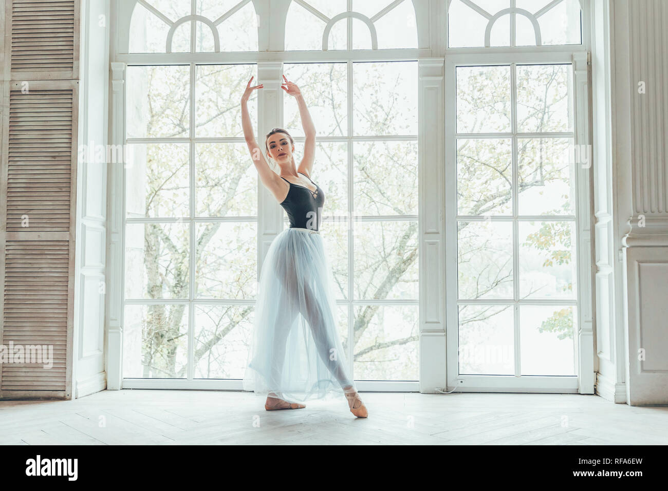 Young classical ballet dancer woman in dance class. Beautiful graceful ...