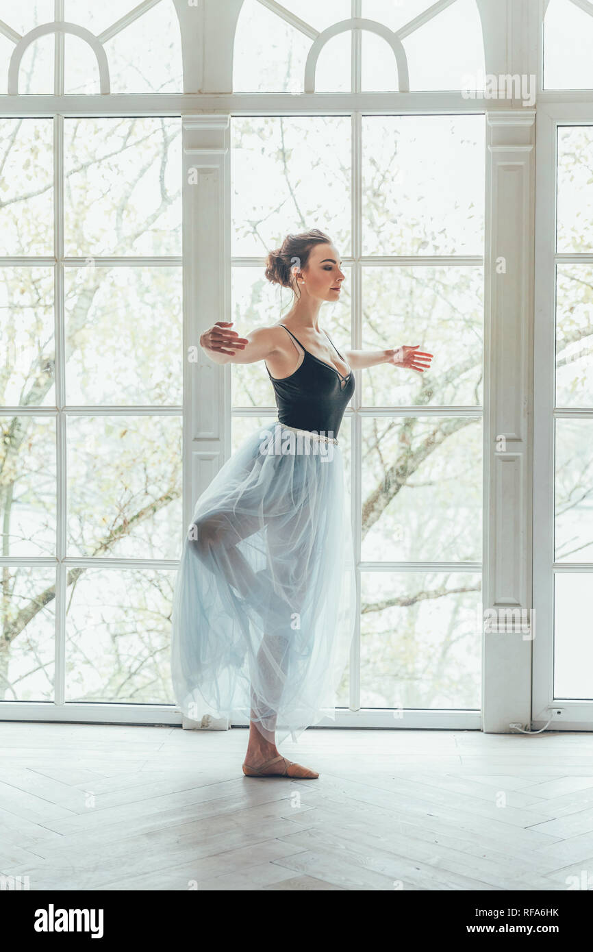 Young classical ballet dancer woman in dance class. Beautiful graceful ballerina practice ballet ...