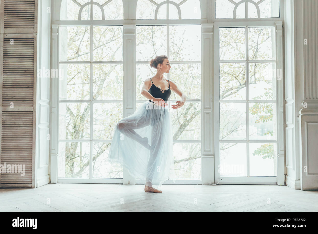 Young classical ballet dancer woman in dance class. Beautiful graceful ballerina practice ballet ...