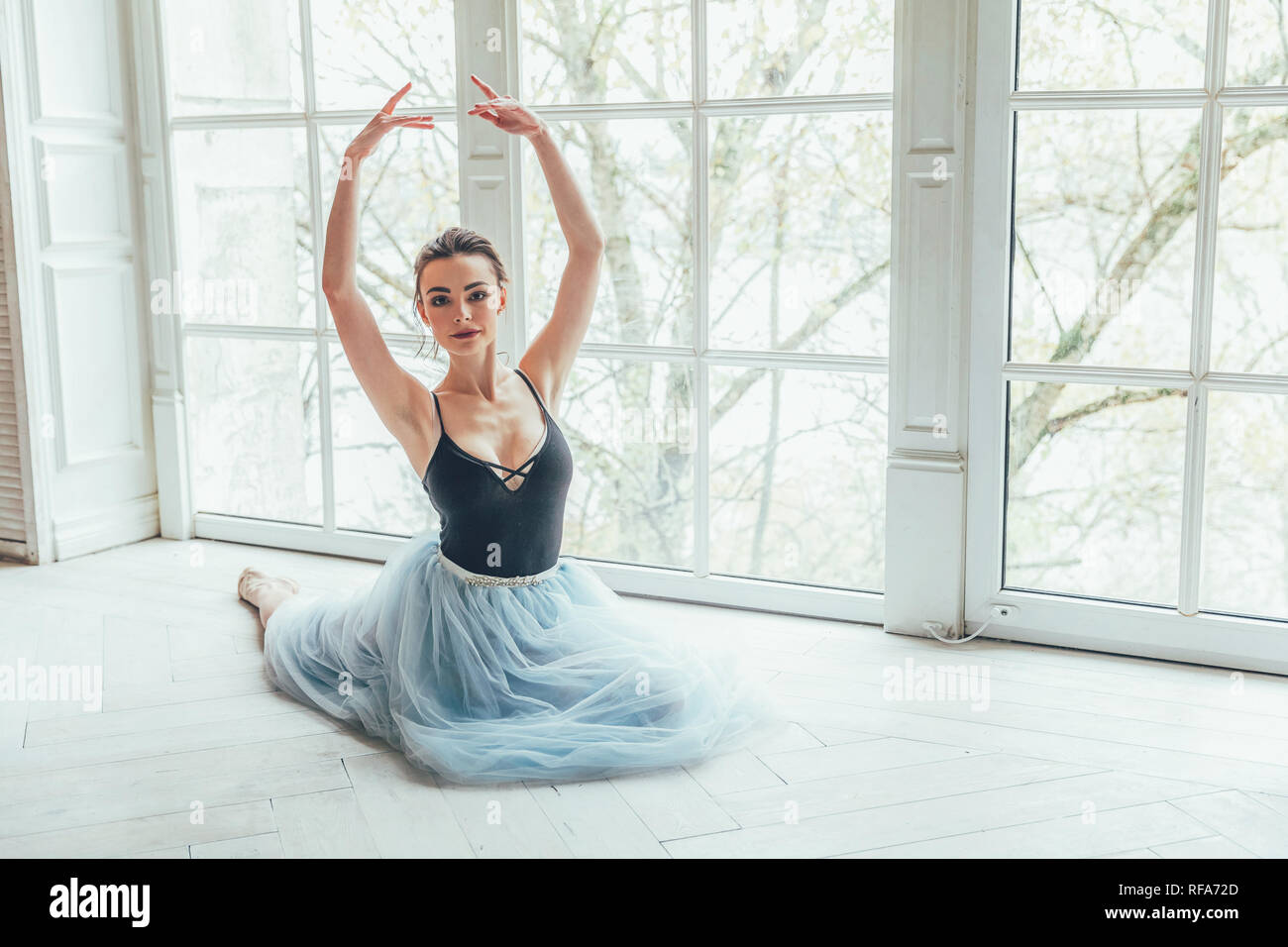Young classical ballet dancer woman in dance class. Beautiful graceful ...