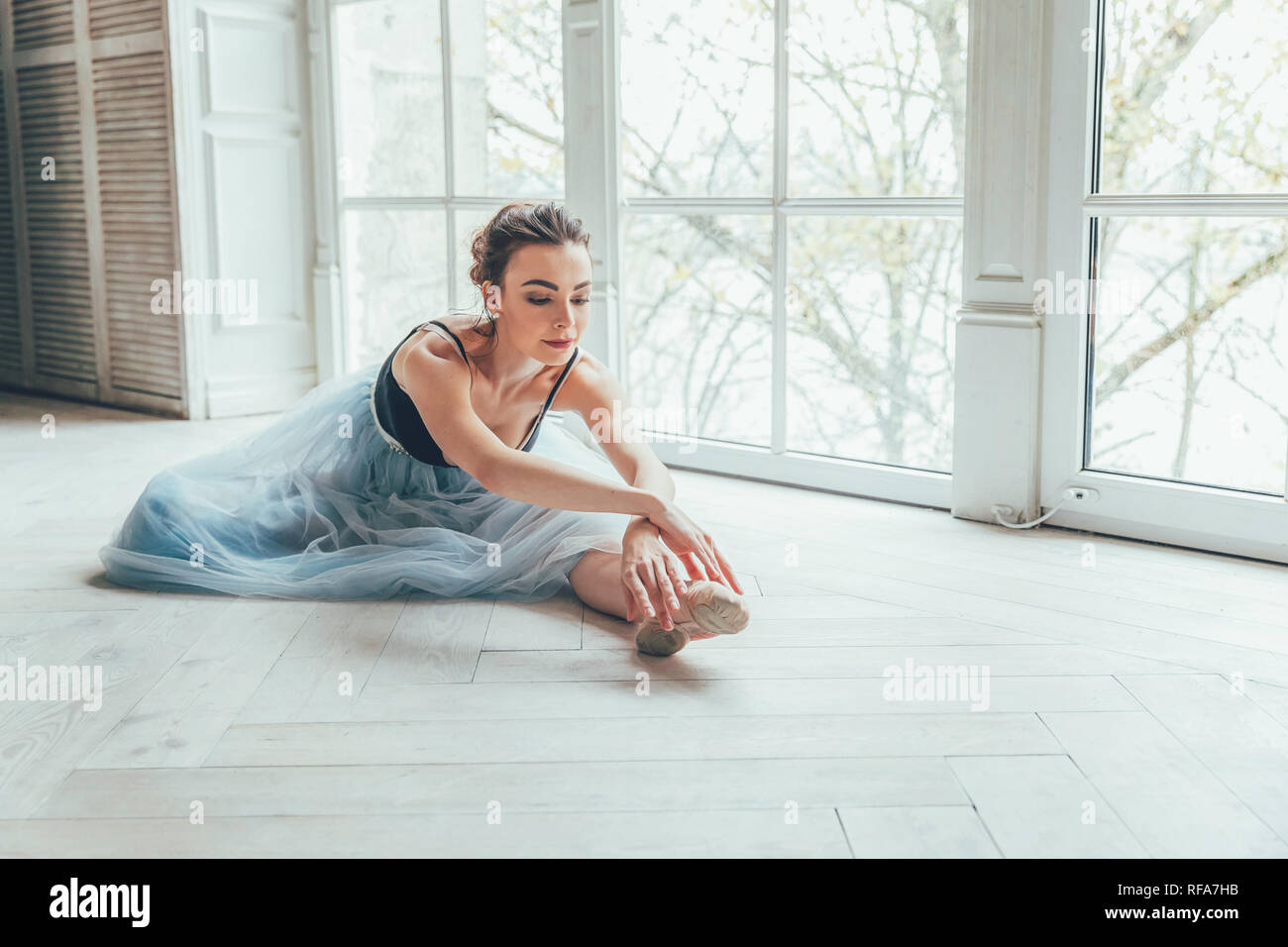 Young classical ballet dancer woman in dance class. Beautiful graceful ballerina practice ballet ...
