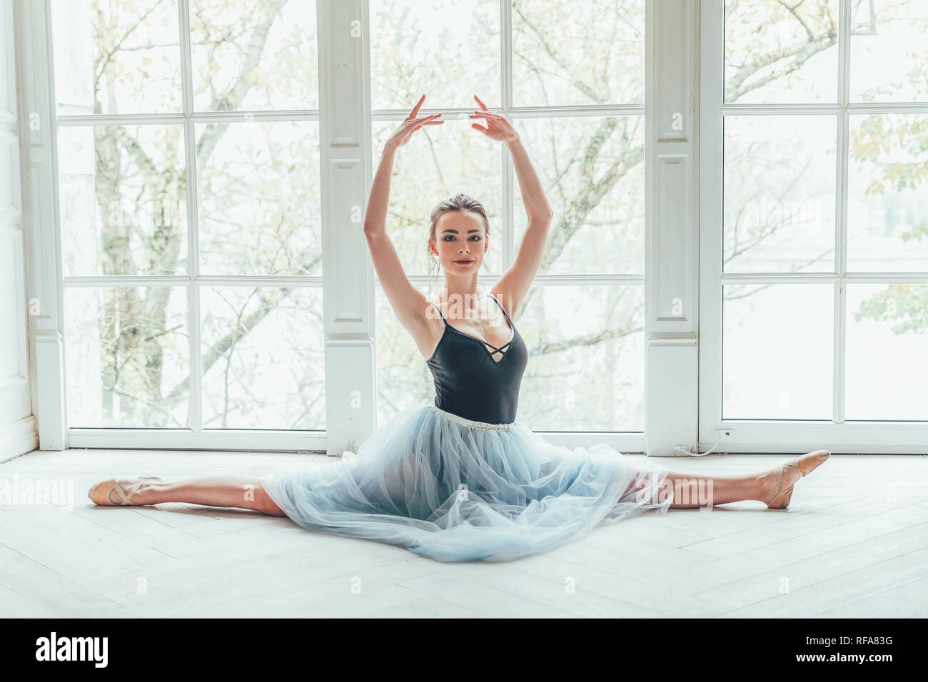 Young classical ballet dancer woman in dance class. Beautiful graceful ballerina practice ballet ...