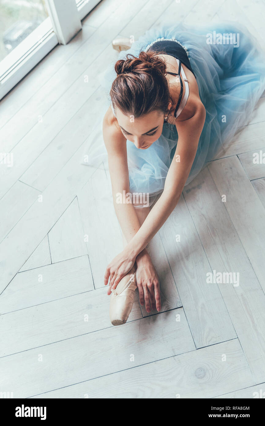 Young classical ballet dancer woman in dance class. Beautiful graceful ballerina practice ballet ...