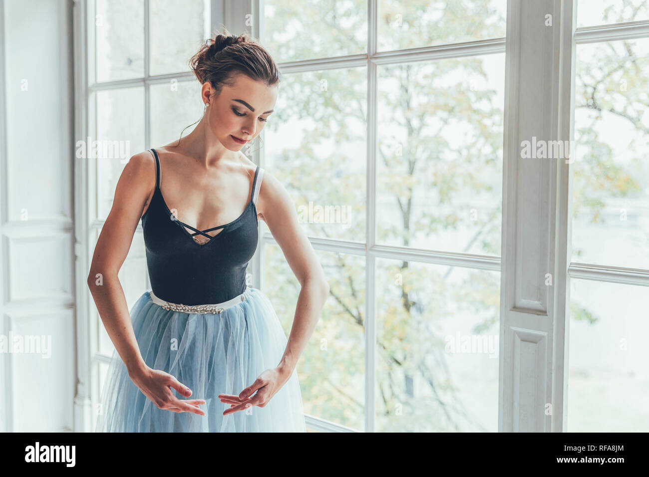 Young classical ballet dancer woman in dance class. Beautiful graceful ballerina practice ballet ...