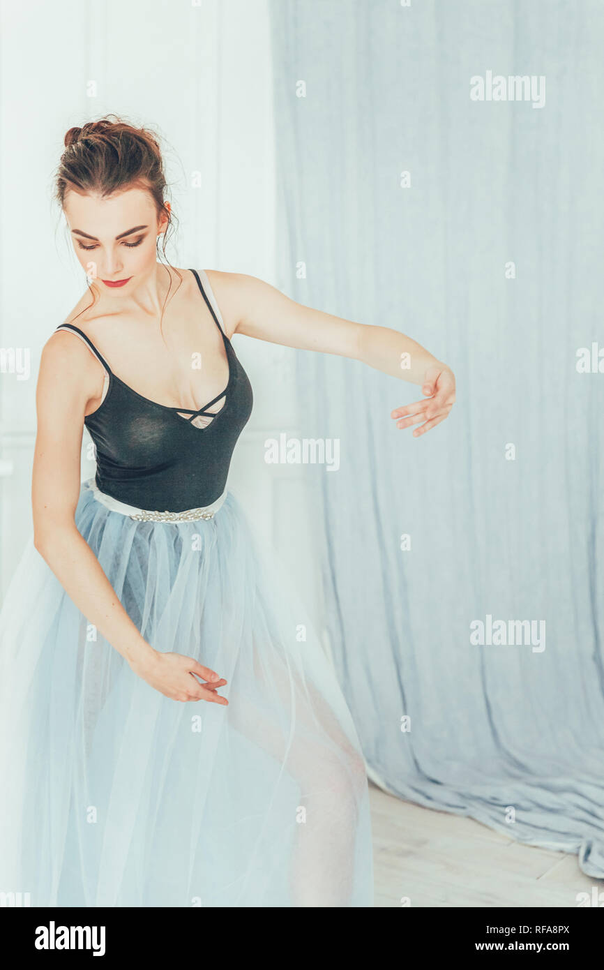 Young classical ballet dancer woman in dance class. Beautiful graceful ballerina practice ballet ...