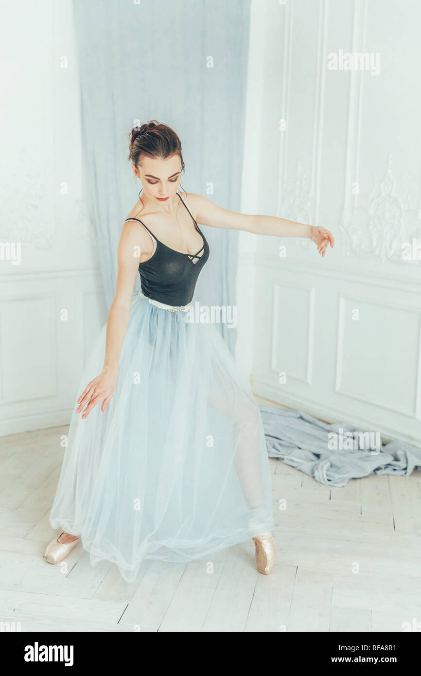 Young classical ballet dancer woman in dance class. Beautiful graceful ballerina practice ballet ...