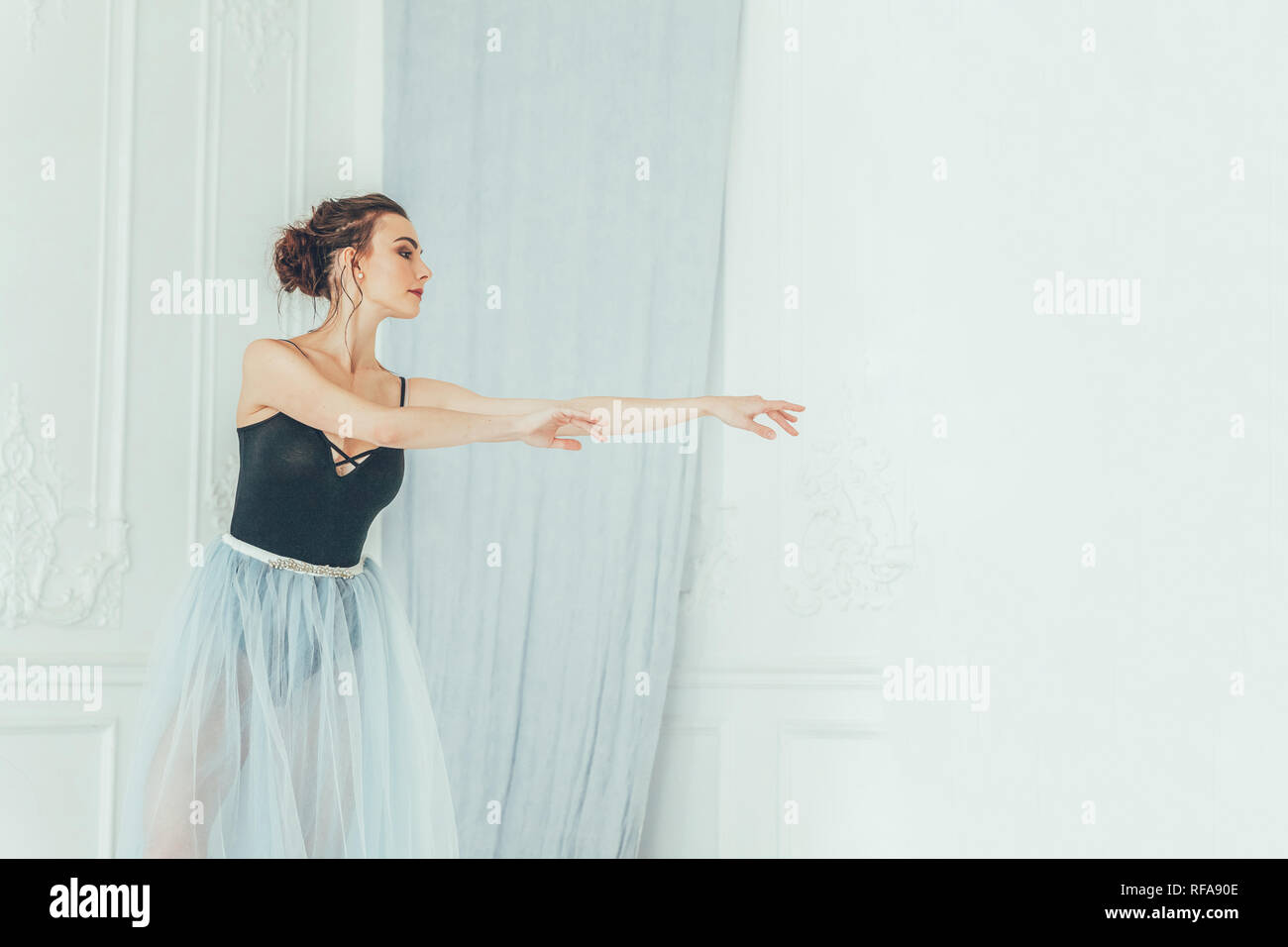 Young classical ballet dancer woman in dance class. Beautiful graceful ballerina practice ballet ...
