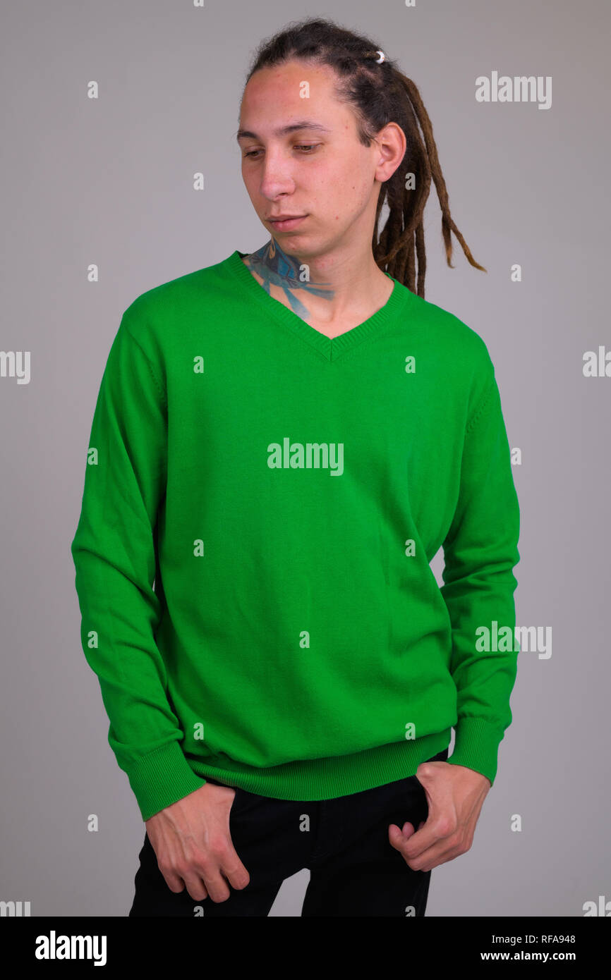 Portrait of serious young handsome man with dreadlocks thinking Stock ...