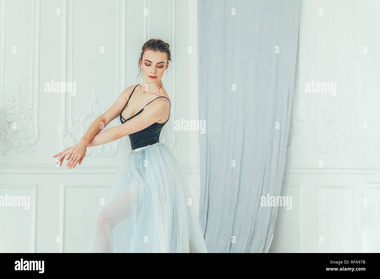 Young classical ballet dancer woman in dance class. Beautiful graceful ballerina practice ballet ...