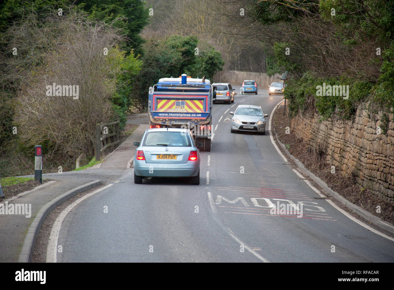 UK road scenes featuring a bus, lorry, and cars navigating winding ...