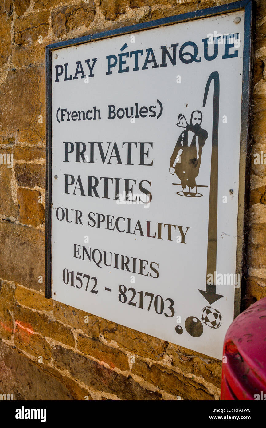 A sign advertising a petanque court in an English village location ...