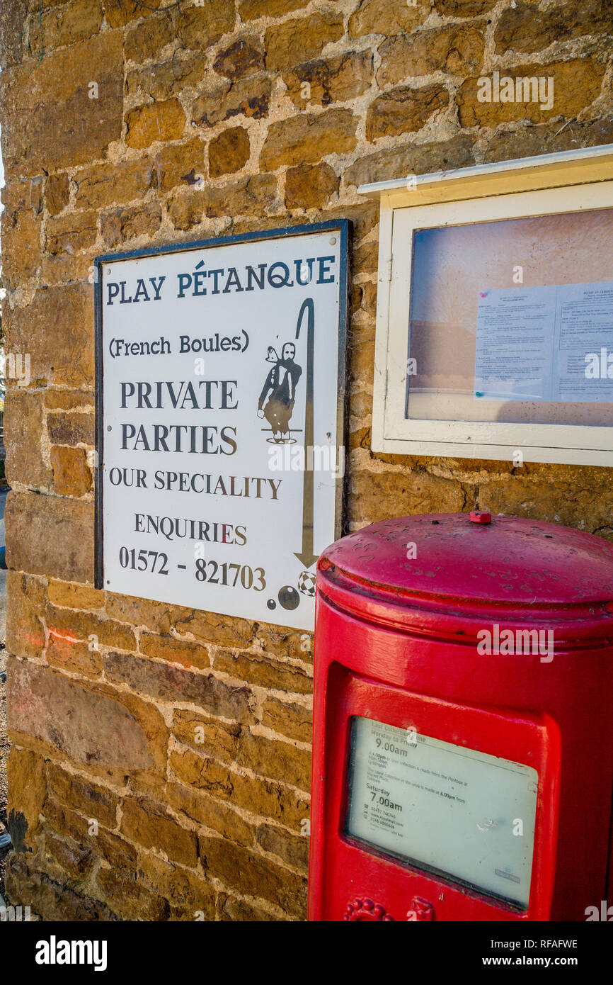 A sign advertising a petanque court in an English village location ...