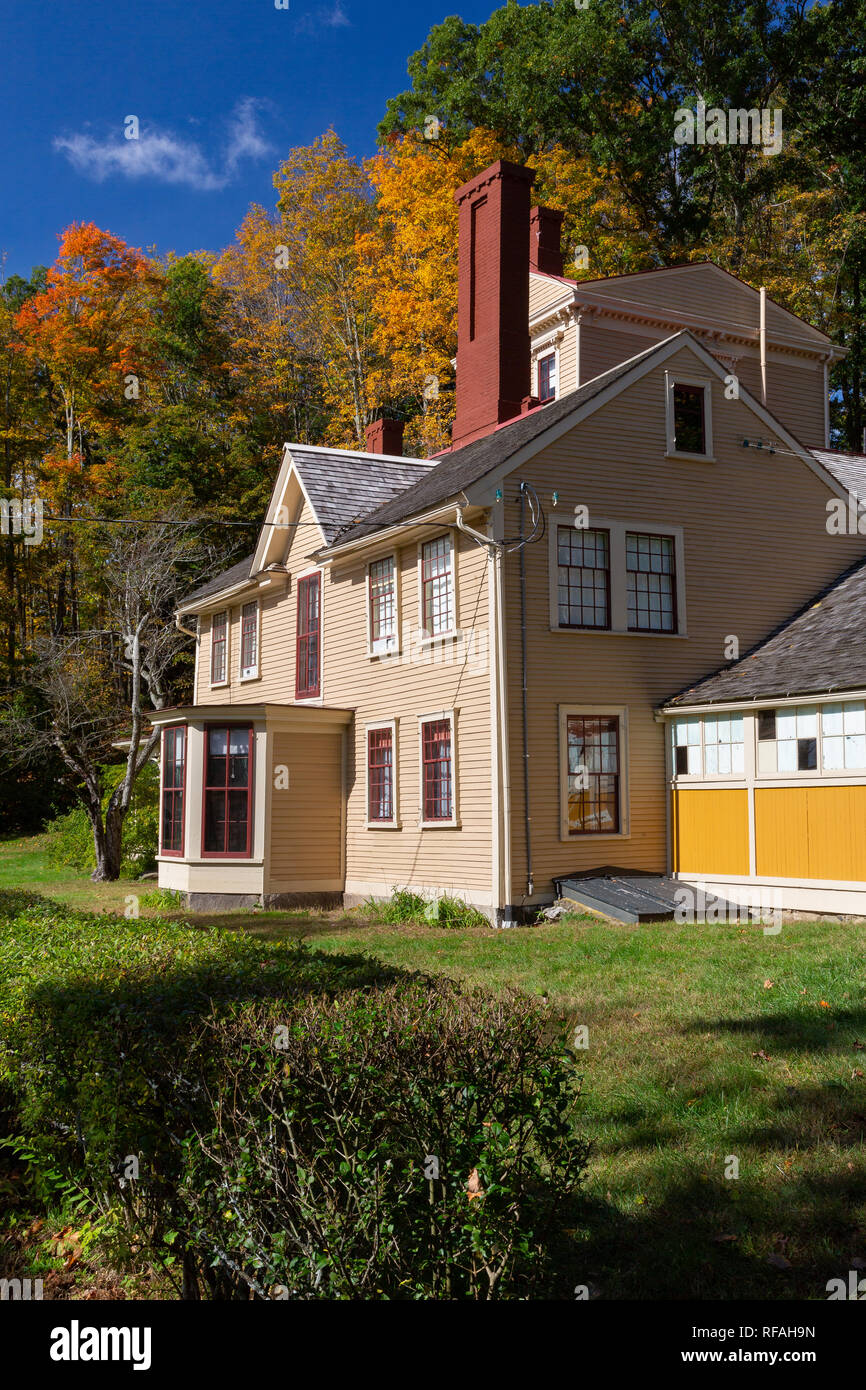 The Wayside House standing beneath fall colors on the surrounding trees ...