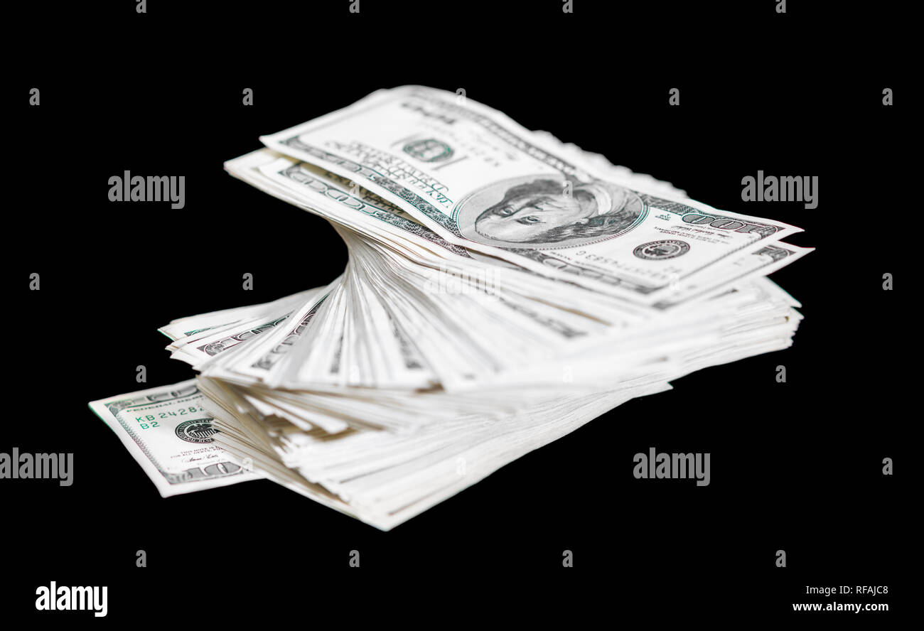 Spiral stack of 100 USD banknotes on a black background conceptual of ...