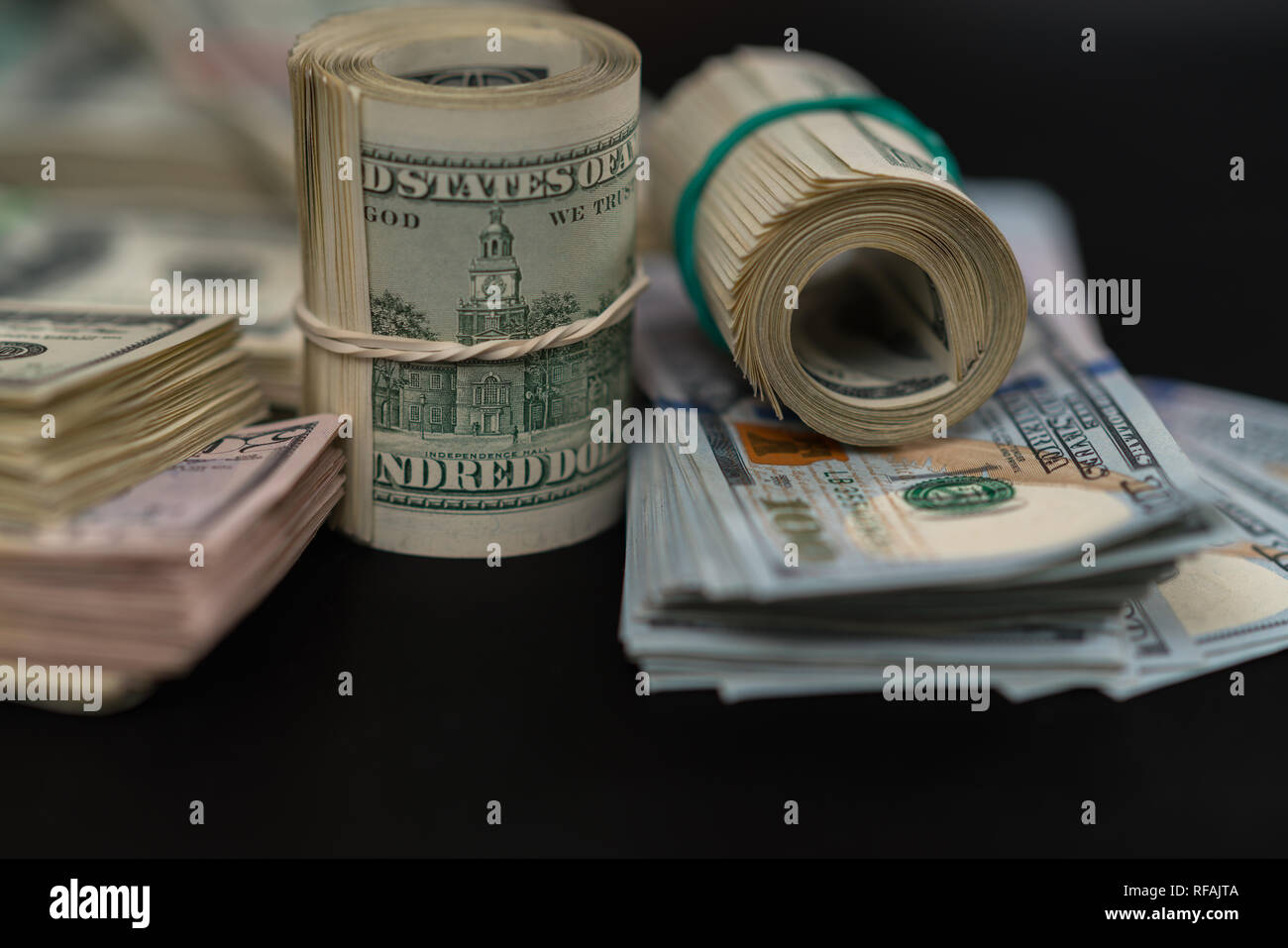 Large stash of USD banknotes tied in rolls and bundles in a close up ...