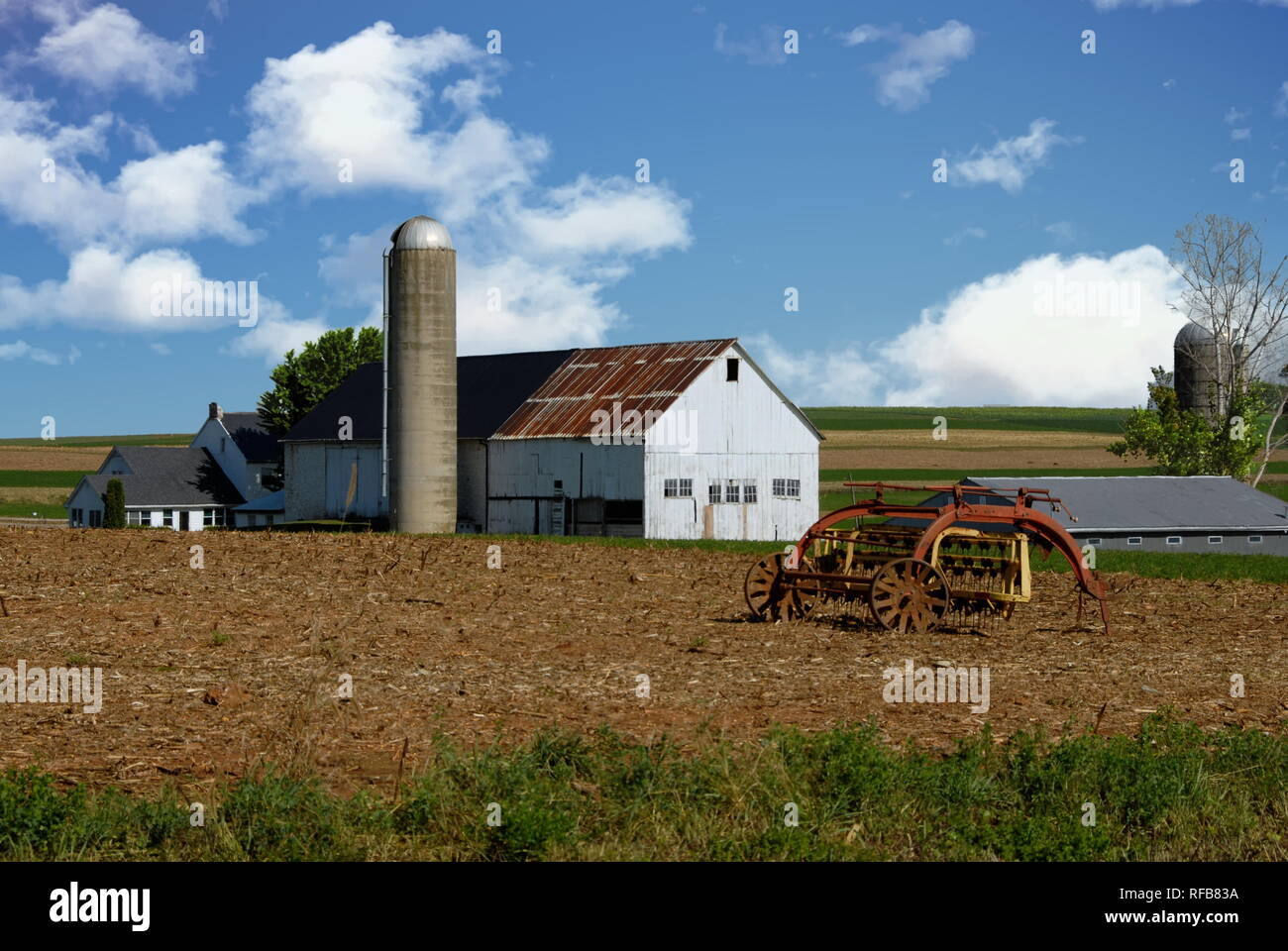 Amish Farm With Old Rusty Vintage Farm Equipment Setting in the Field ...