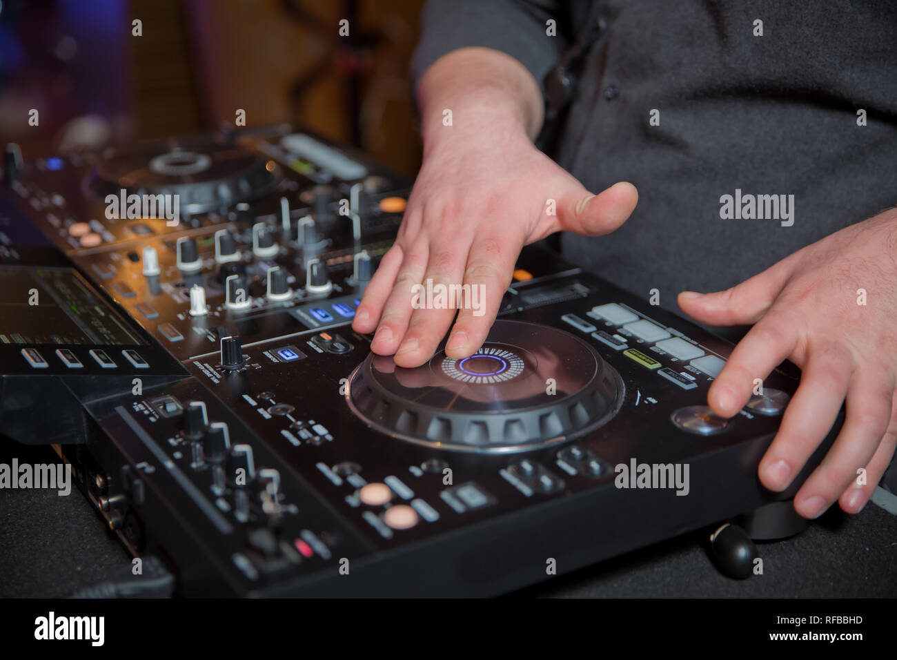 DJ playing music at mixer closeup . Close up of DJ hands mixing music ...
