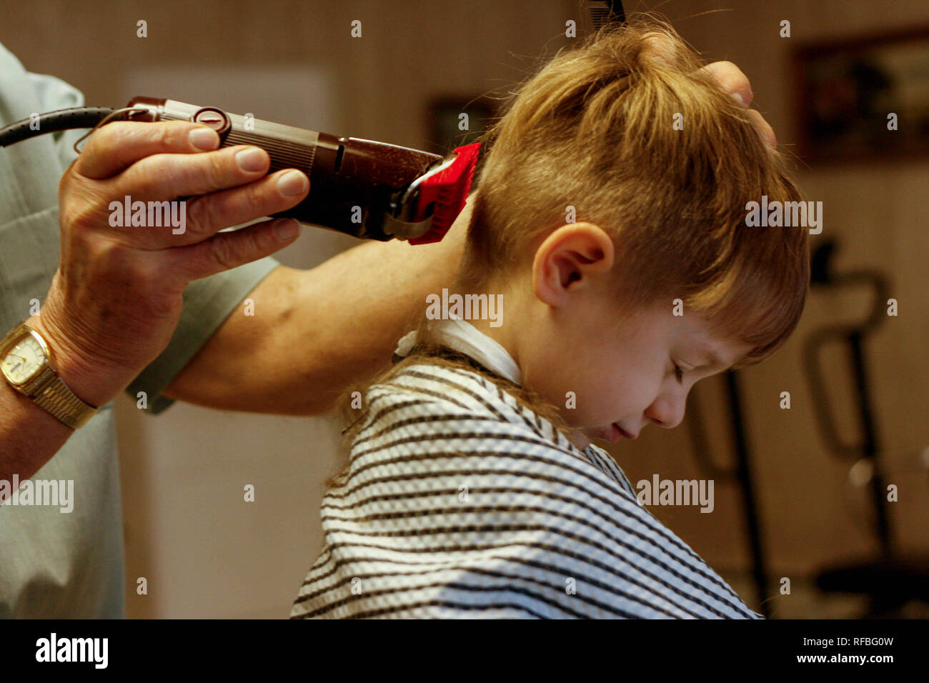 Barber cutting boy's hair hi-res stock photography and images - Alamy