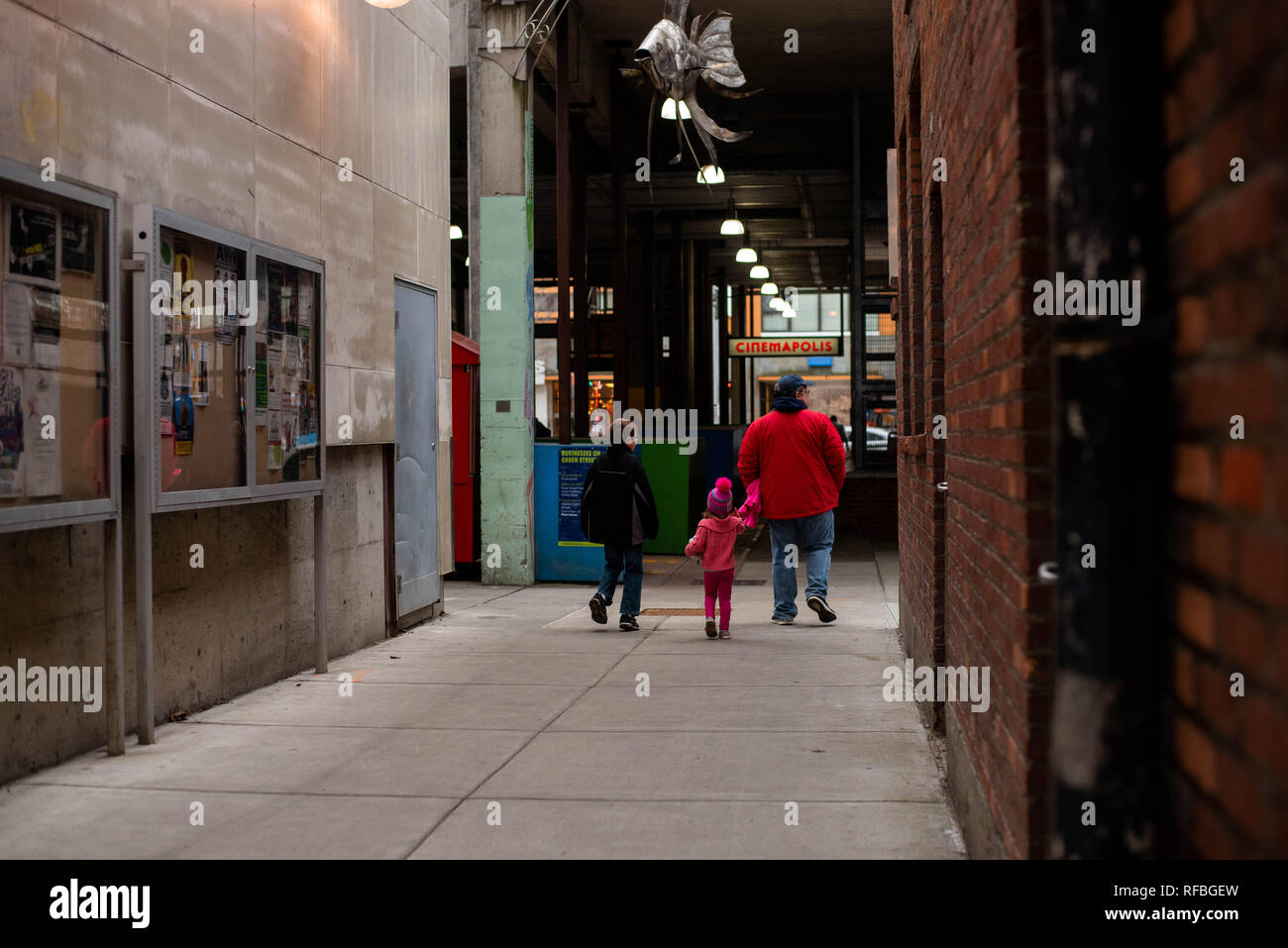 A family walks down and alley in Ithaca NY, SA Stock Photo - Alamy