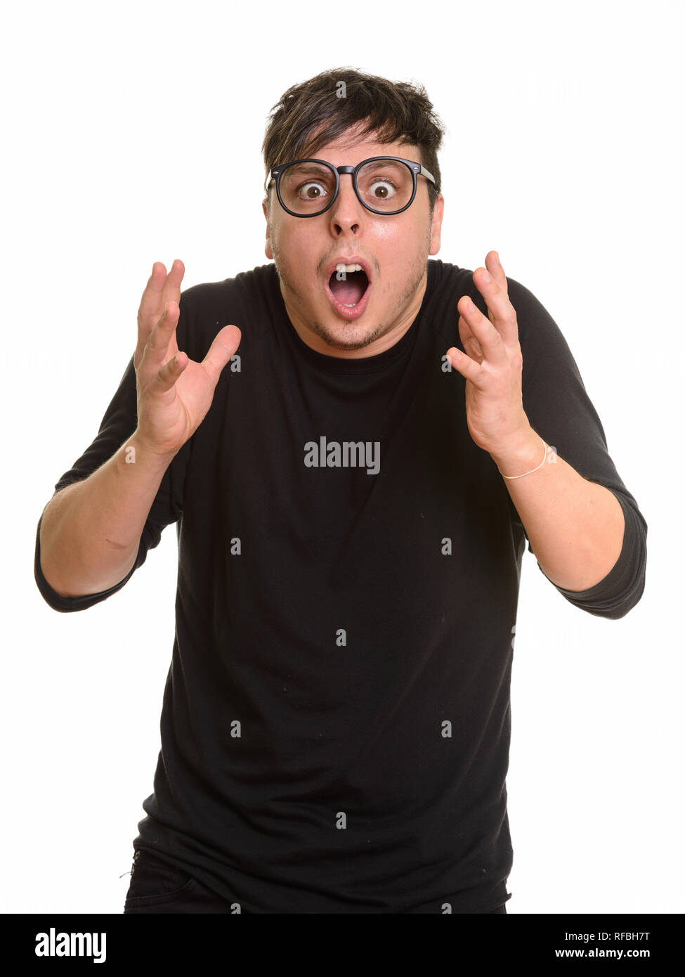 Studio shot of Caucasian man looking shocked Stock Photo - Alamy